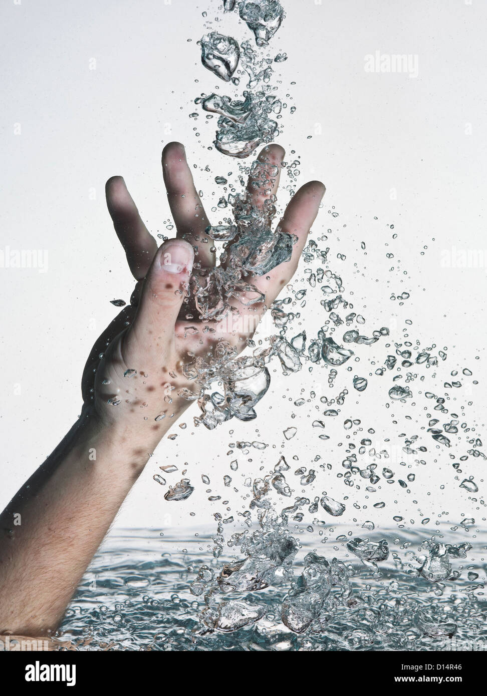 Hand thrust into water Stock Photo - Alamy