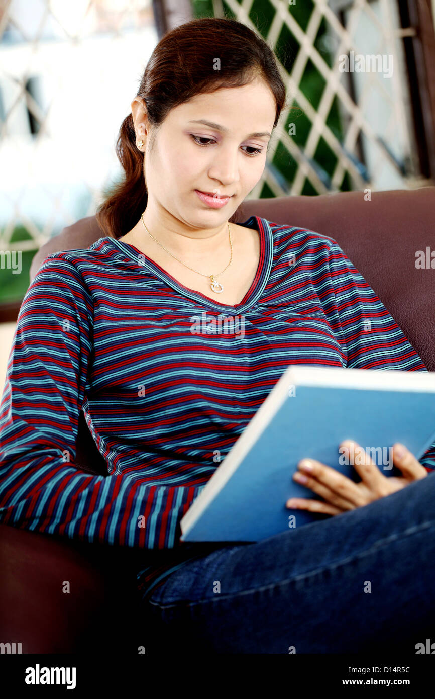 Female student reading book Stock Photo - Alamy