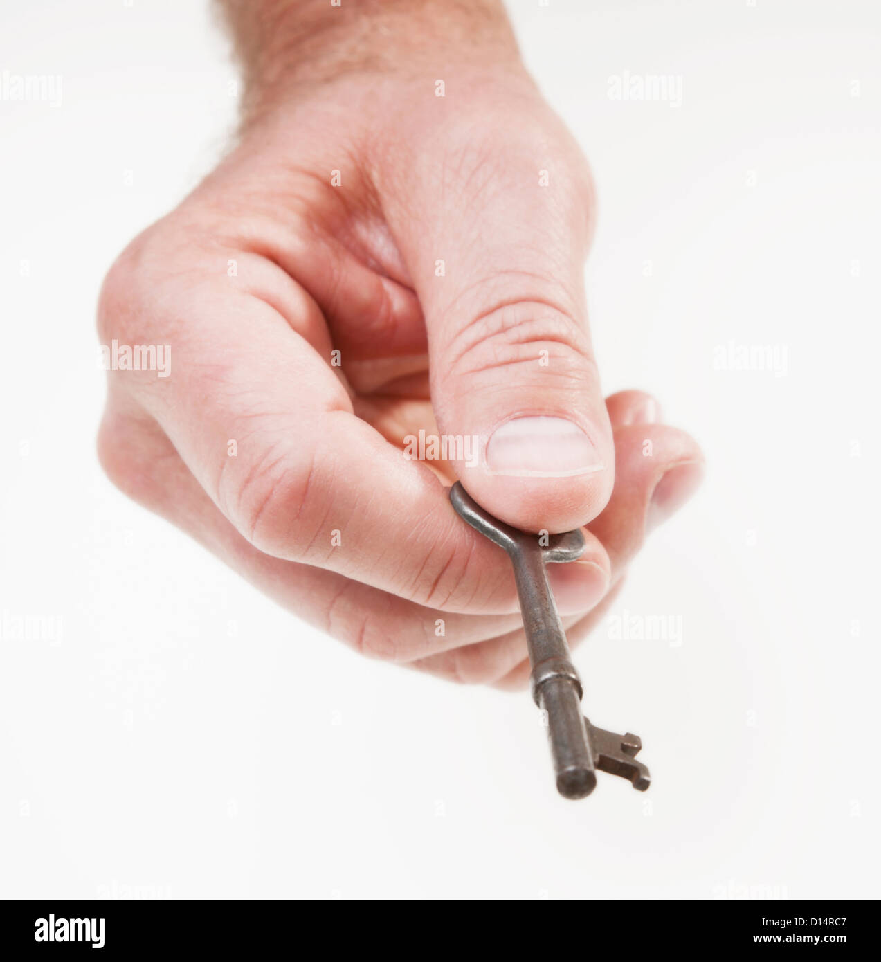 Hand holding antique key Stock Photo - Alamy