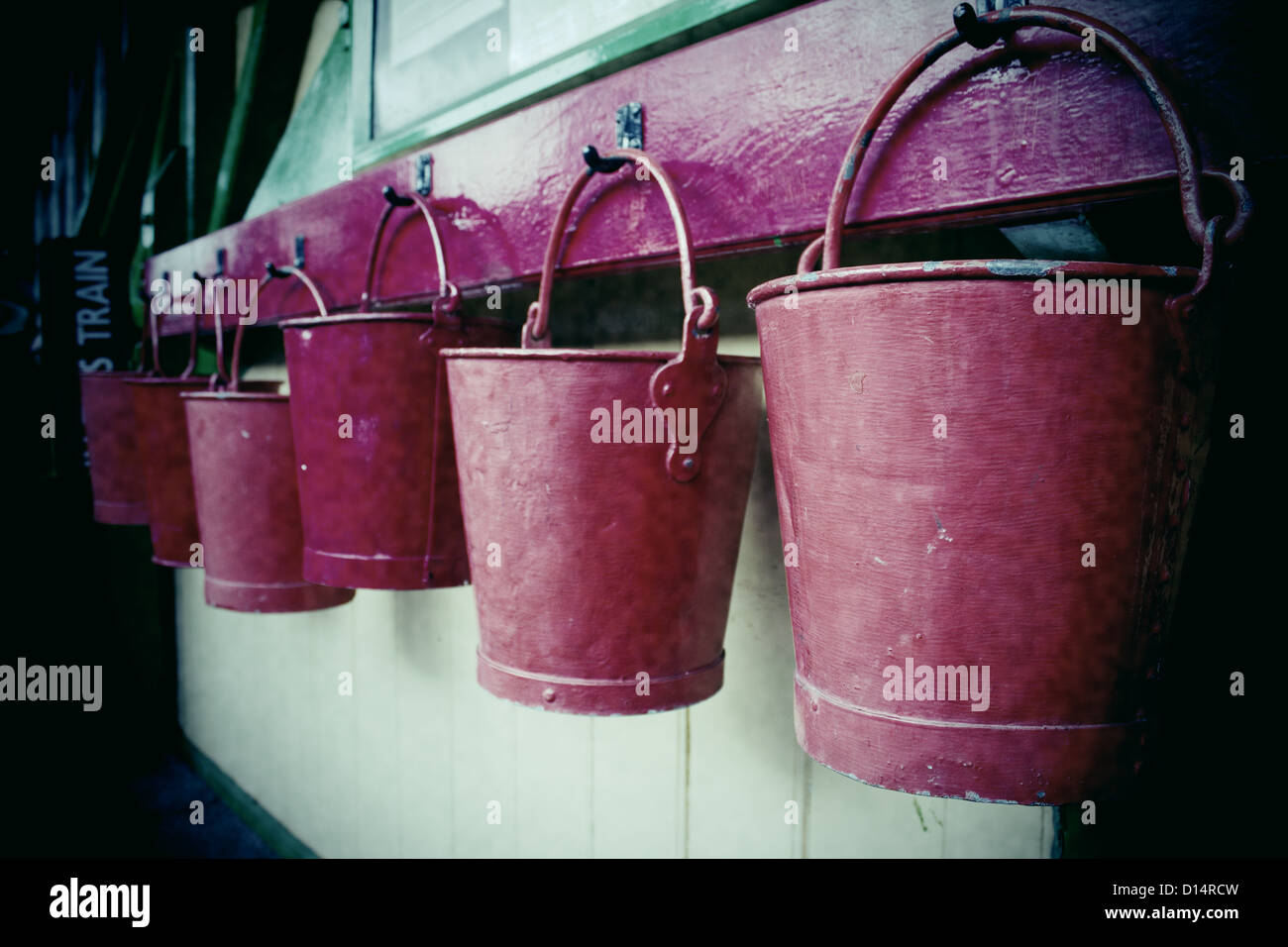 Old Red Fire Buckets hanging at a Train Station Platform Stock Photo ...
