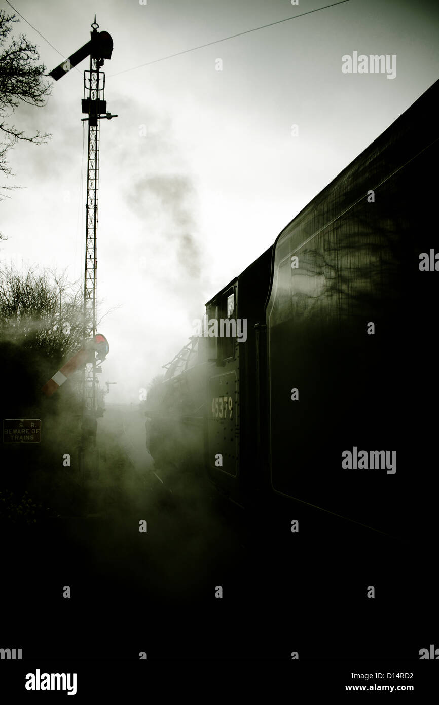 Signal with old steam train Stock Photo - Alamy