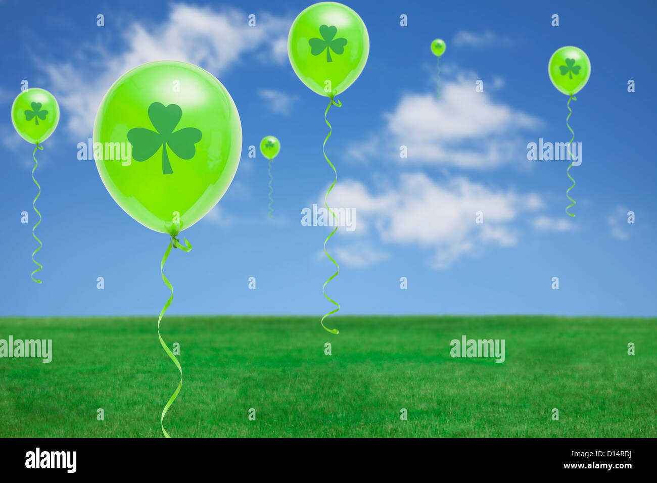 Green balloons flying above green meadow Stock Photo - Alamy