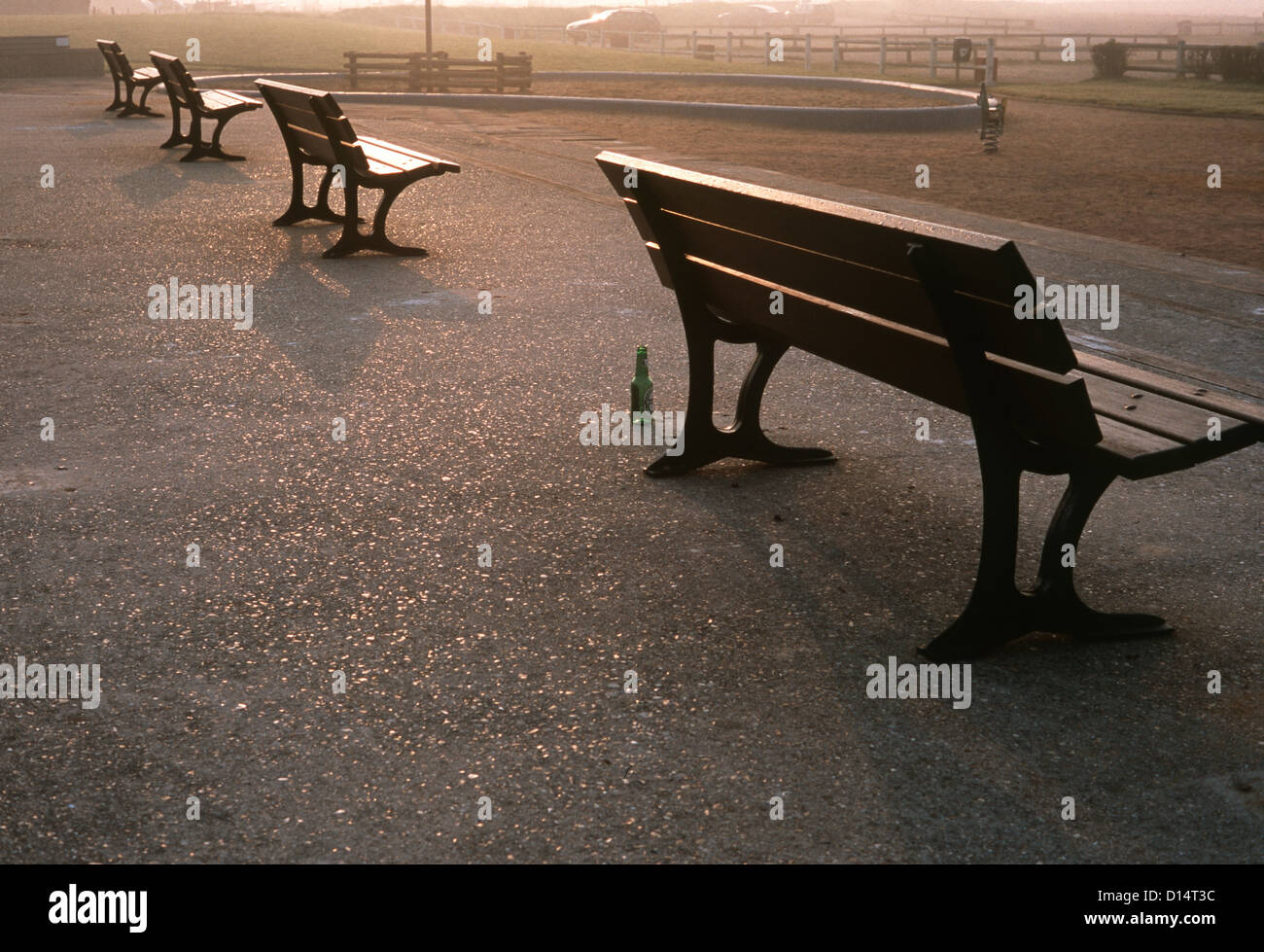 Empty benches, beer bottle, sunrise, early morning Stock Photo - Alamy
