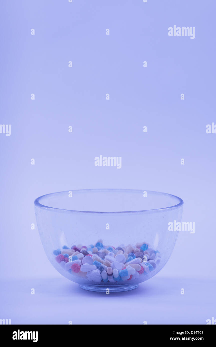 Bowl full of pills Stock Photo - Alamy