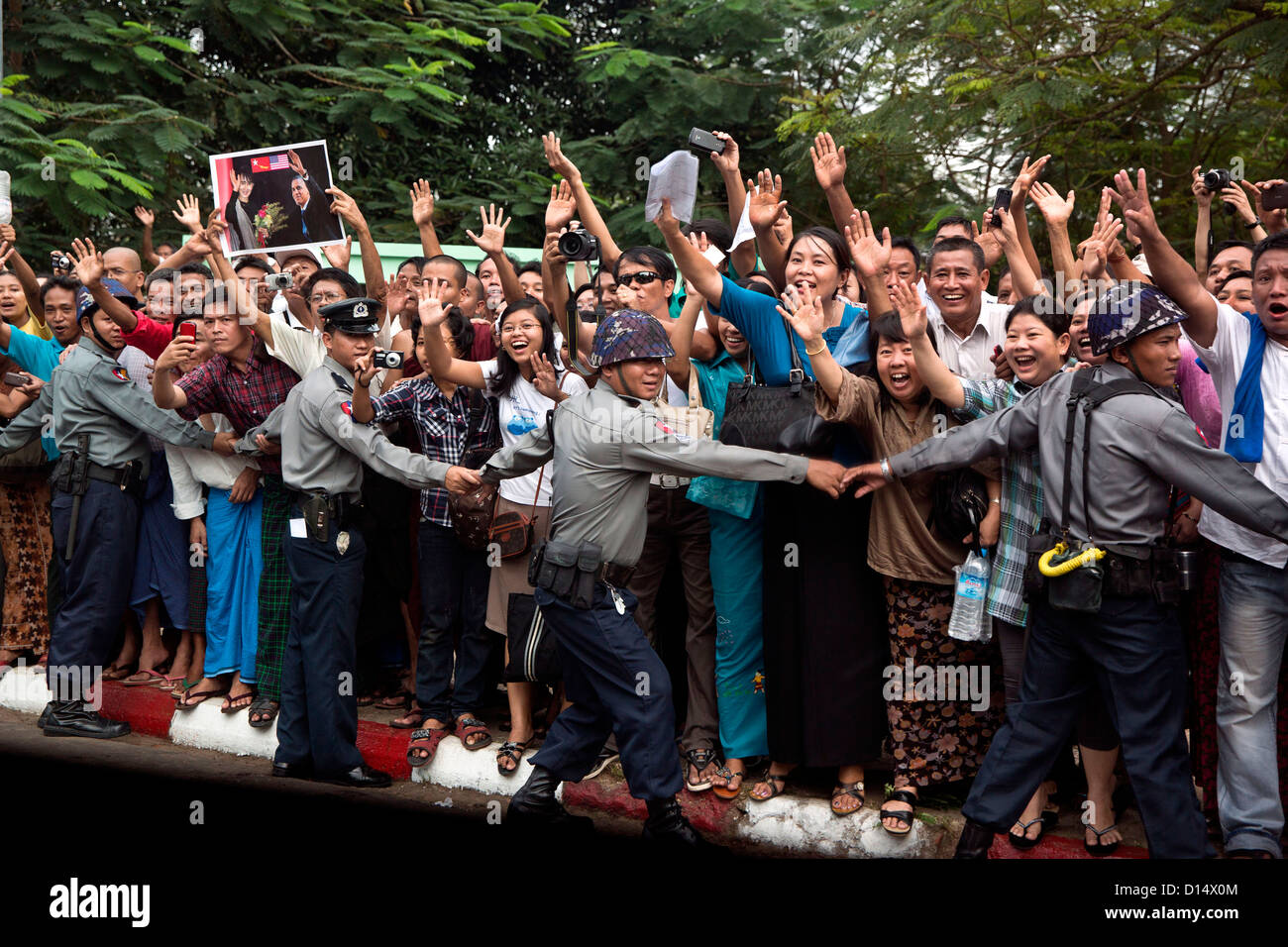 Police hold back crowds as residents line the motorcade route to ...