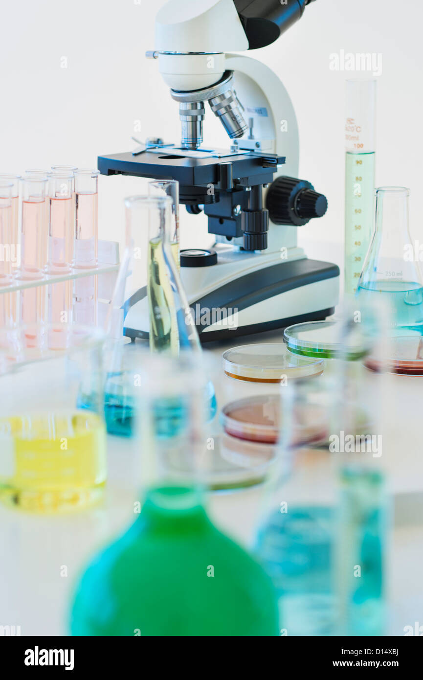 Beakers and microscope Stock Photo - Alamy