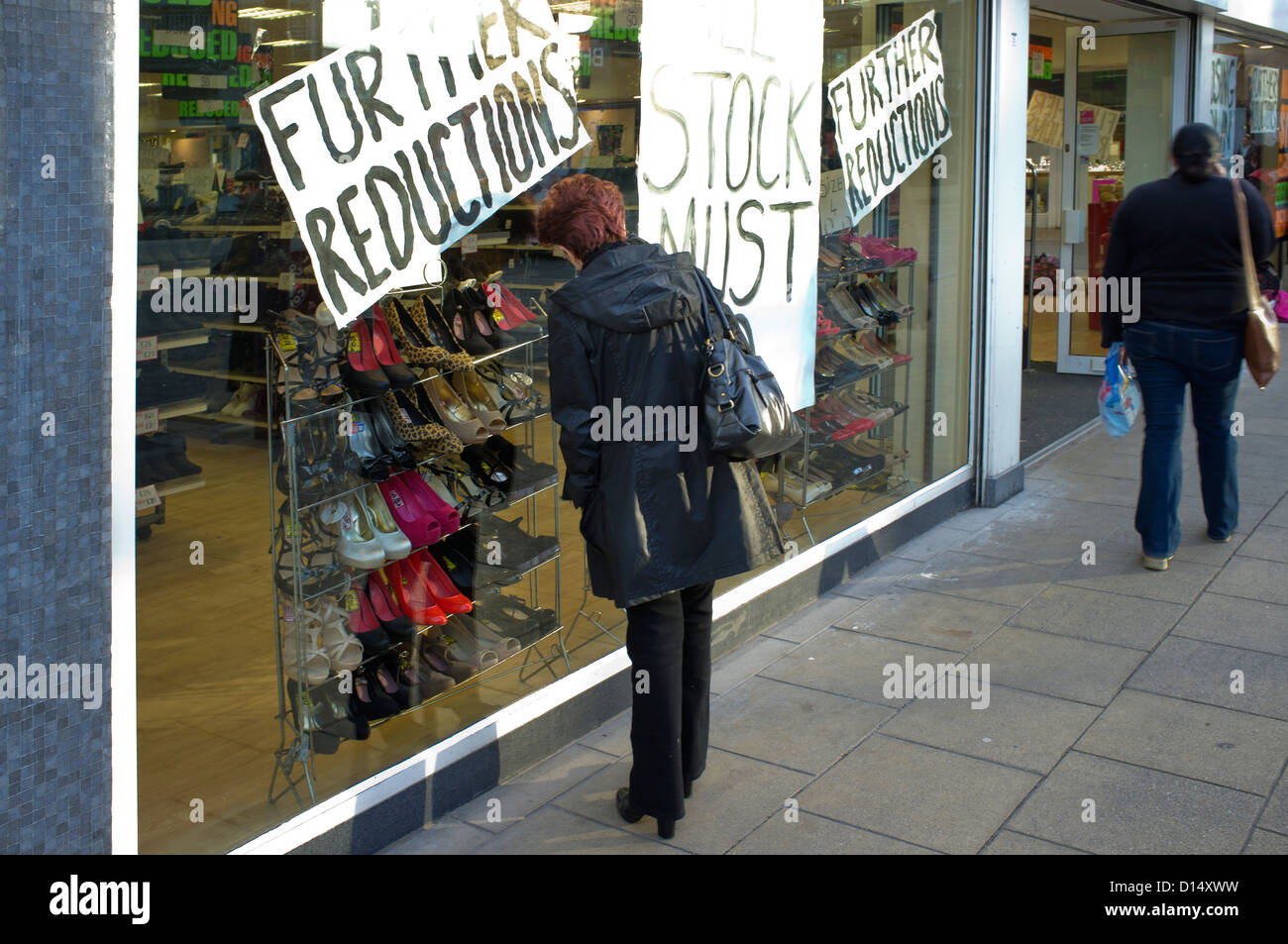 A woman looking in a shop window Stock Photo - Alamy