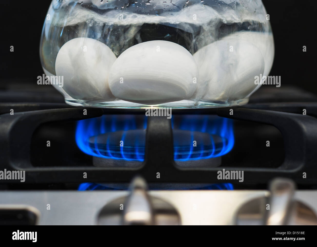 Close-up of eggs boiling on gas burner Stock Photo - Alamy