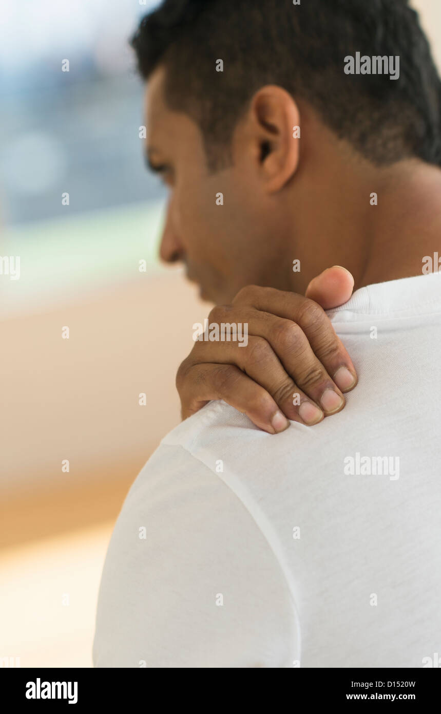 USA, New Jersey, Jersey City, Man massaging his shoulder Stock Photo ...