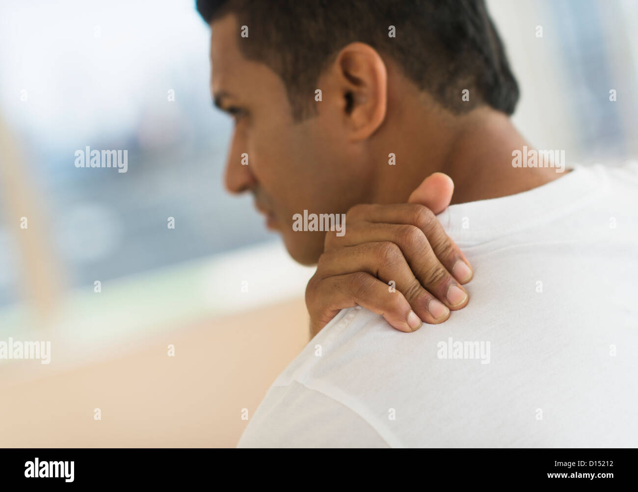 USA, New Jersey, Jersey City, Man massaging his shoulder Stock Photo ...