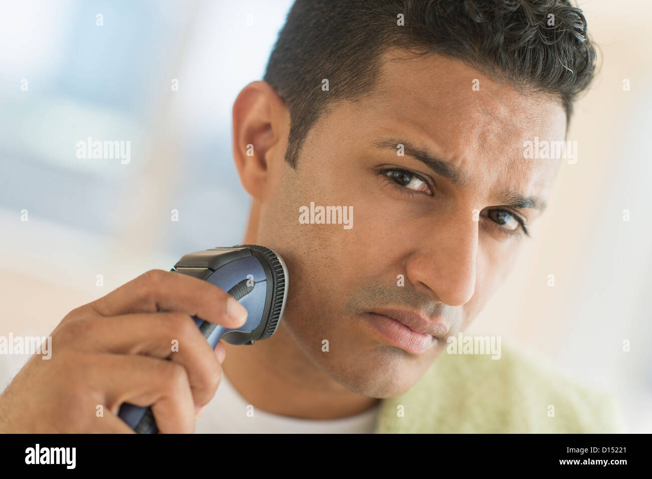 USA, New Jersey, Jersey City, Man shaving with electric razor Stock ...