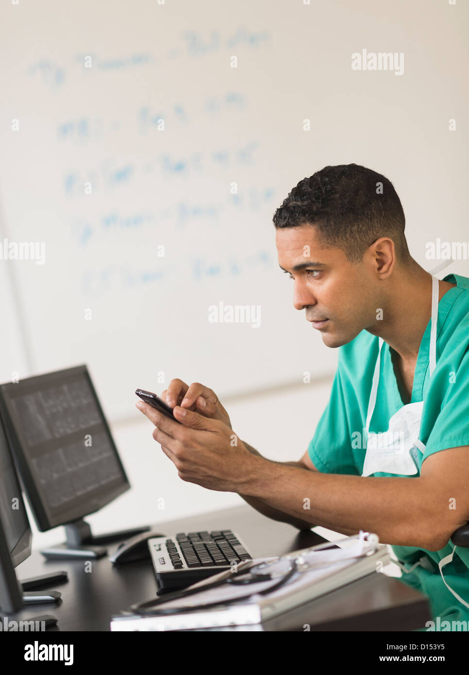 USA, New Jersey, Jersey City, Surgeon working on computer and text ...