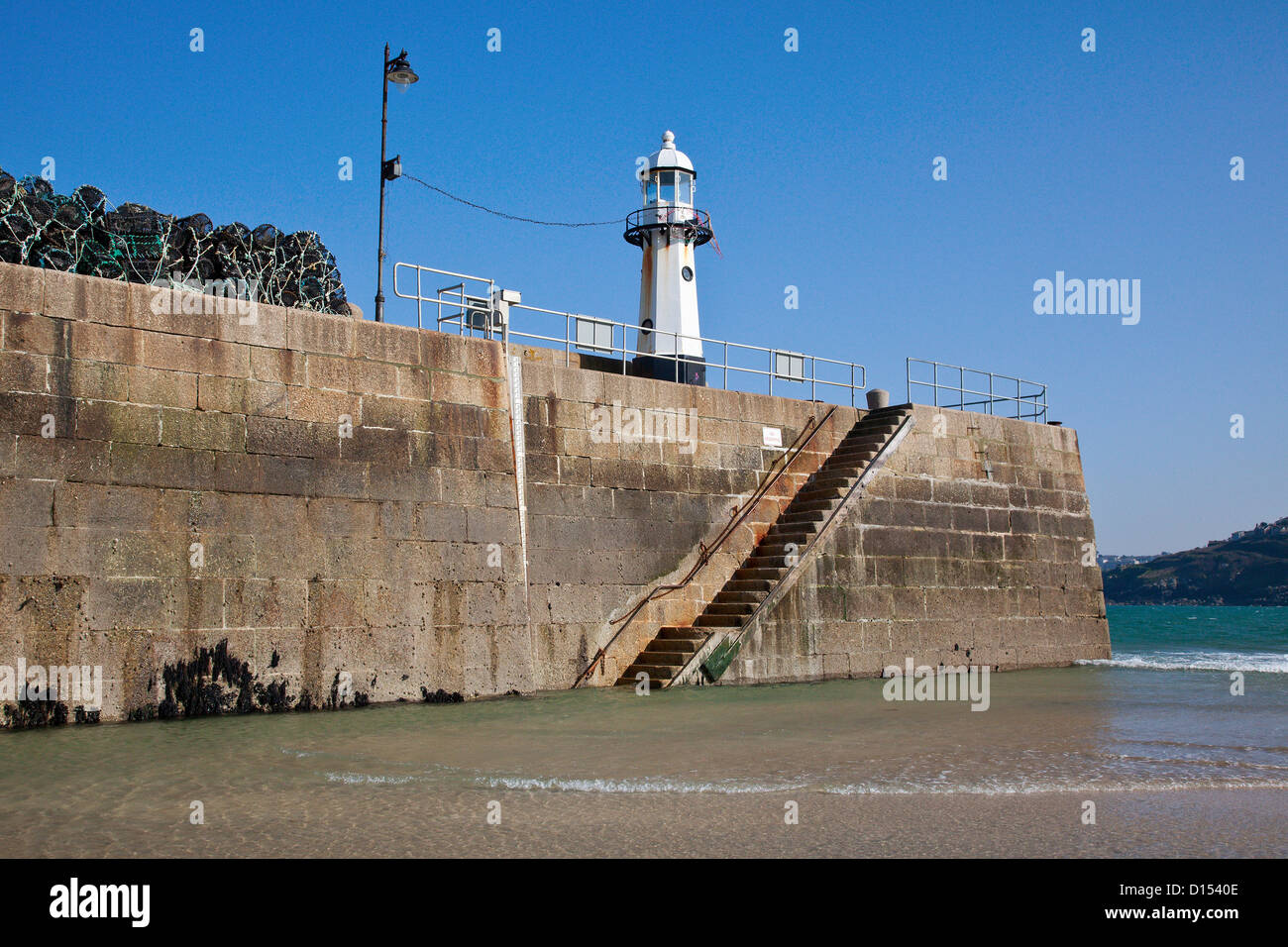 Harbour wall, lighthouse and entrance to harbour at low tide, St Ives ...