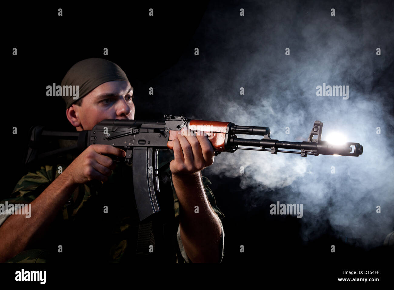 Soldier with rifle, focus on weapon, smoke on background Stock Photo ...