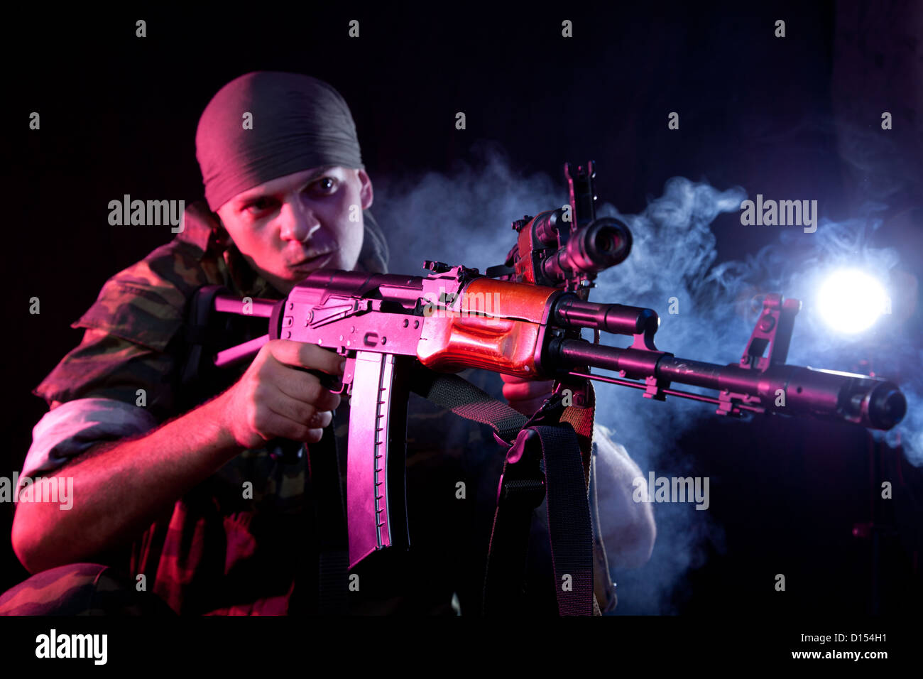 Aggressive soldier in uniform with rifle, focus on weapon Stock Photo ...