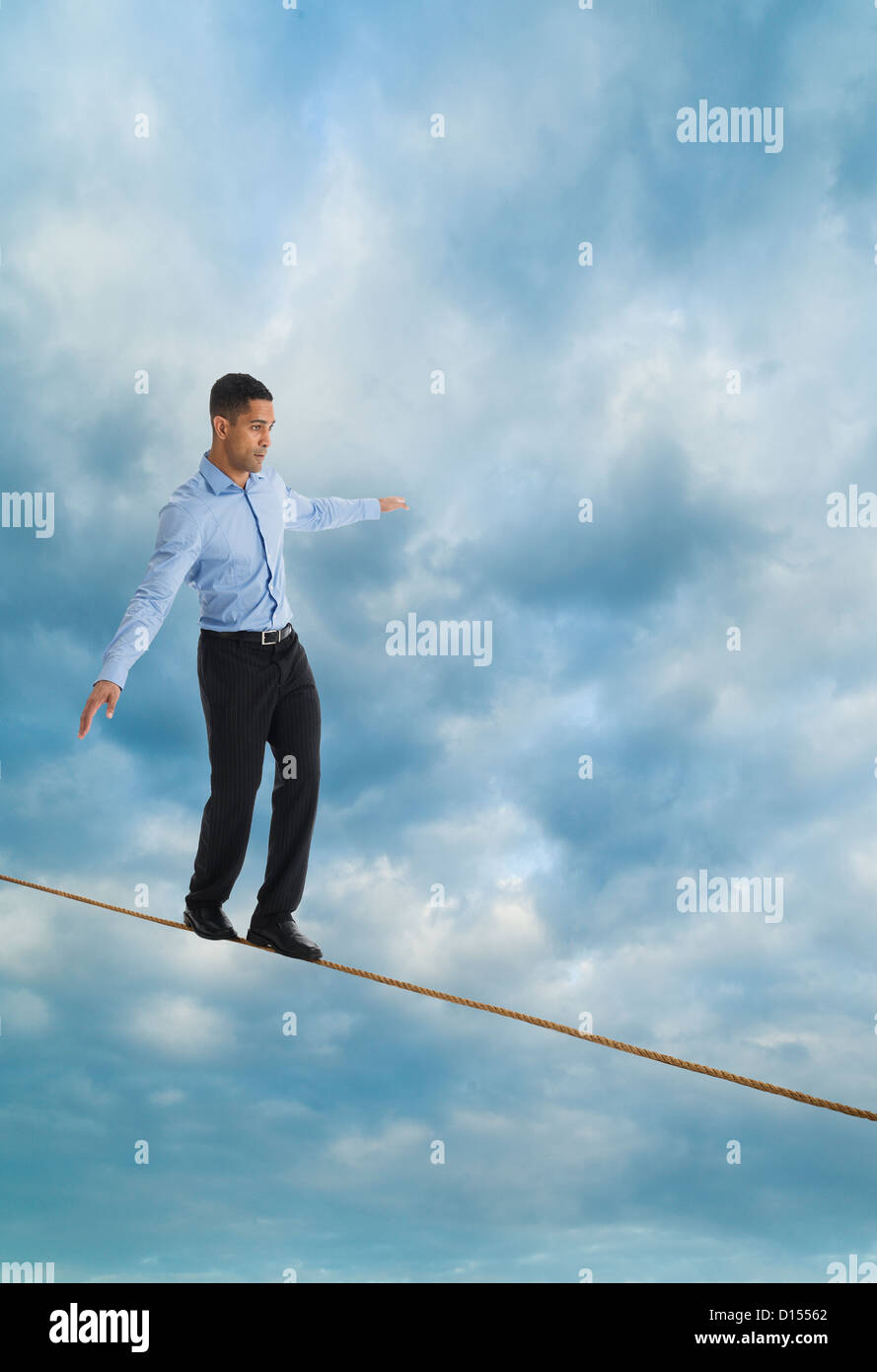 Man balancing on tightrope, studio shot Stock Photo - Alamy
