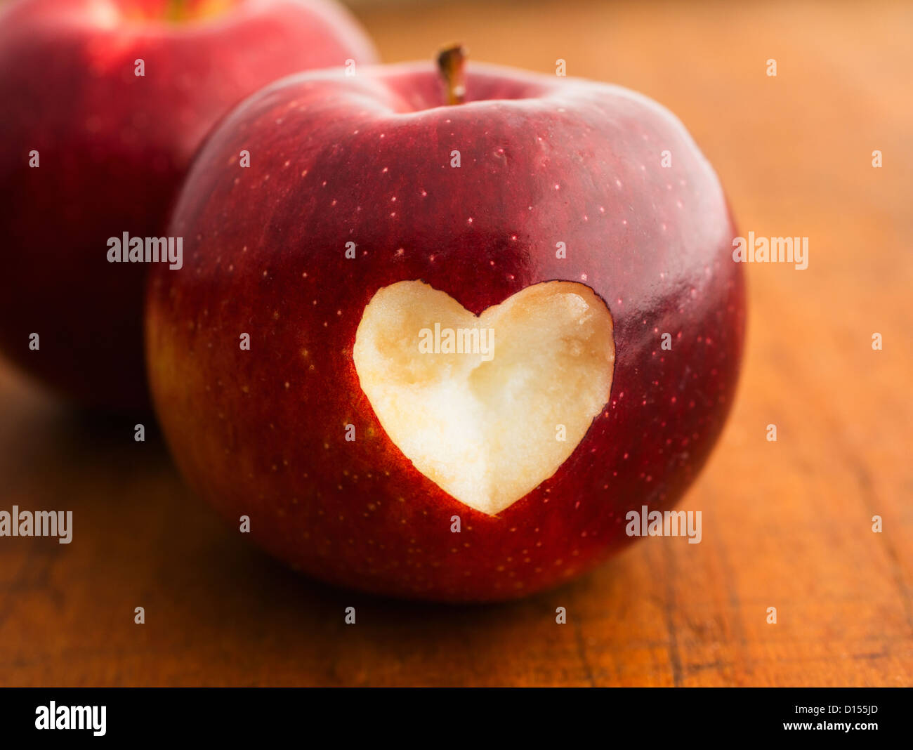 Close up of apple with missing bite in heart shape, studio shot Stock ...