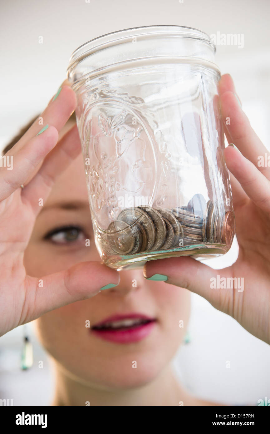 USA, New Jersey, Jersey City, Young woman holding jar with coins Stock ...