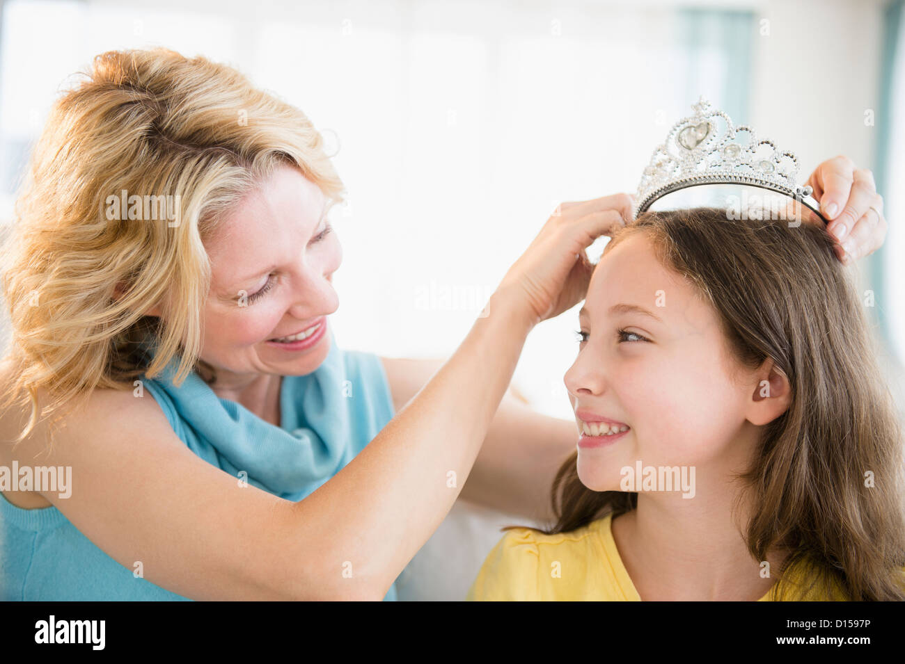 USA, New Jersey, Jersey City, Mother putting tiara on daughter's (8-9 ...
