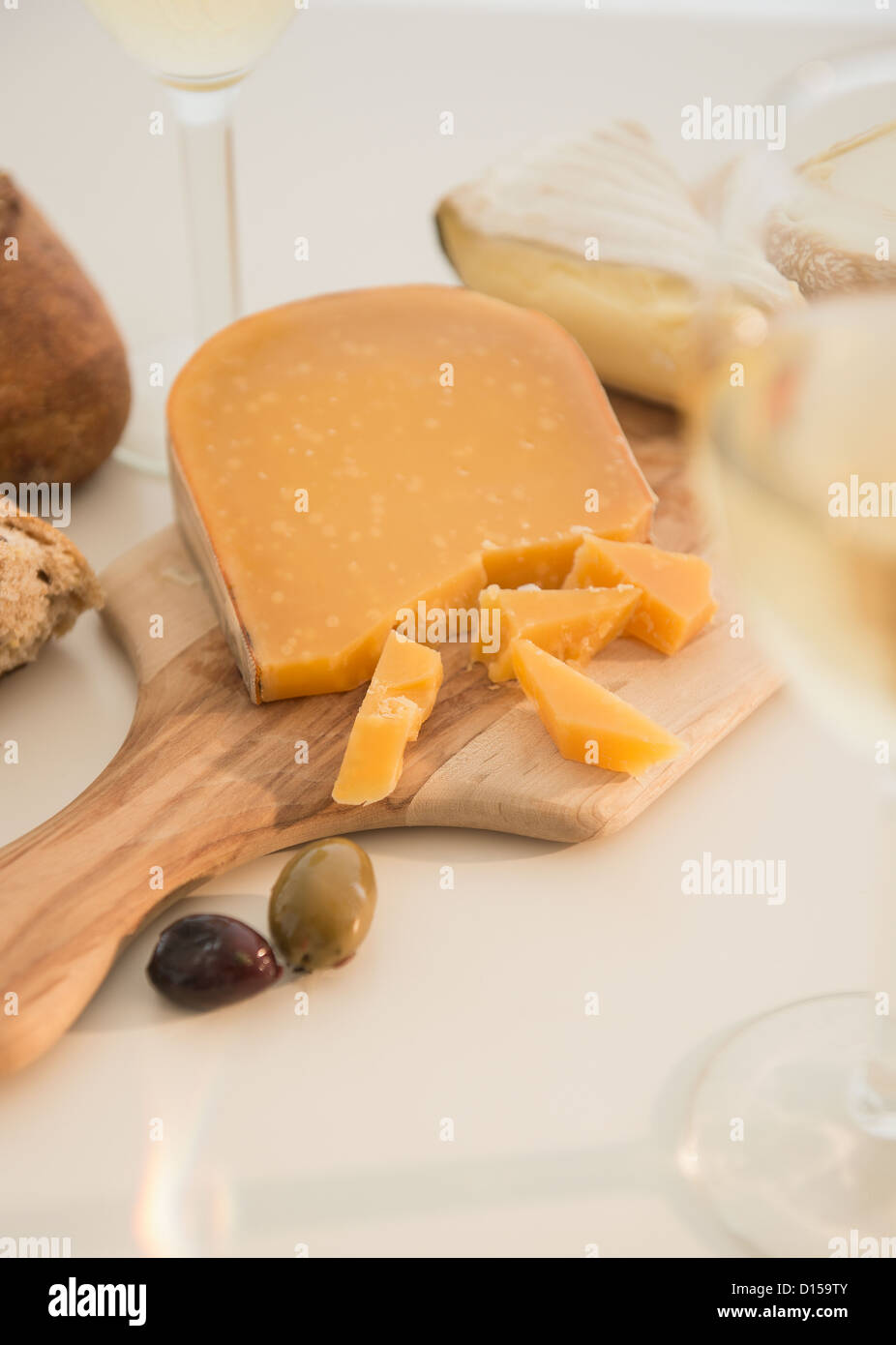 Studio shot of cheese on chopping board Stock Photo - Alamy