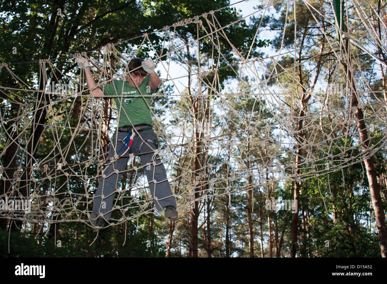 Rope walking boy against forest background Stock Photo - Alamy