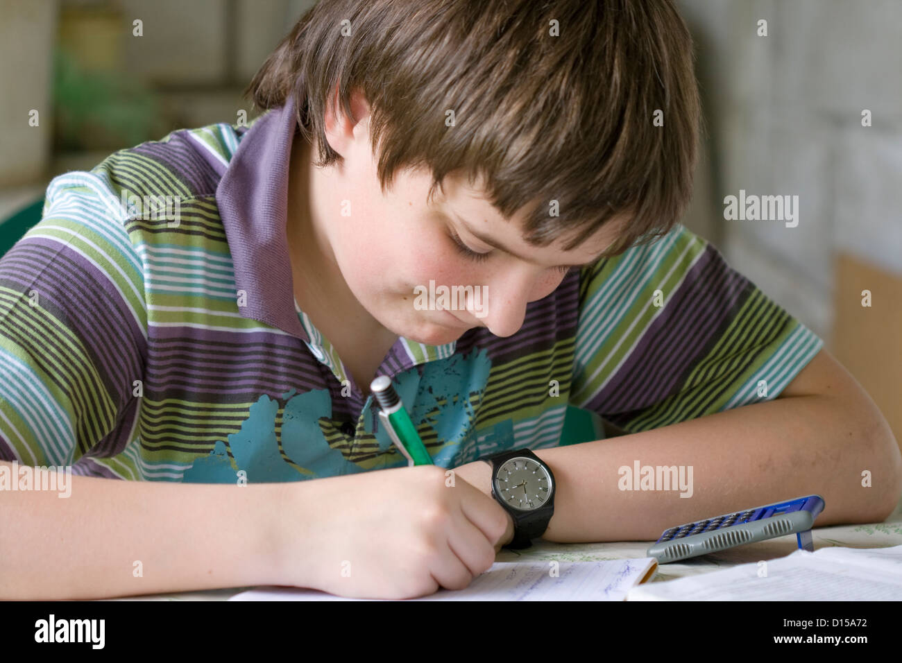 A boy hardly solving homework Stock Photo - Alamy