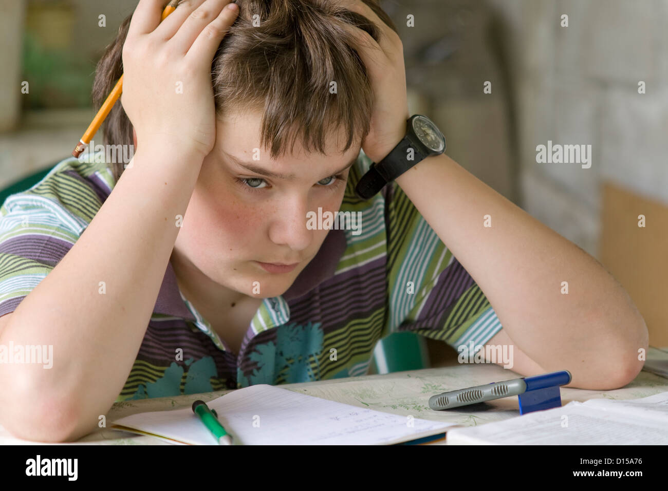 A boy hardly solving homework Stock Photo - Alamy
