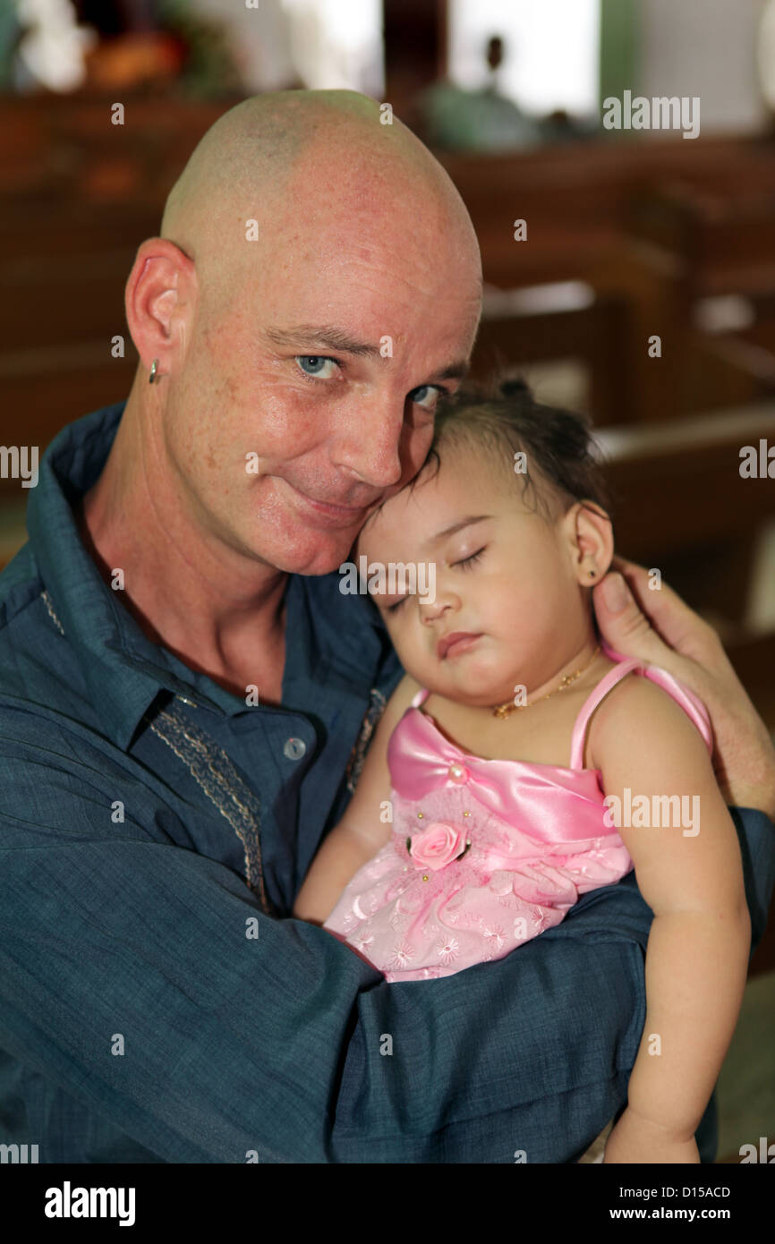 Man cuddles a sleeping baby Stock Photo - Alamy
