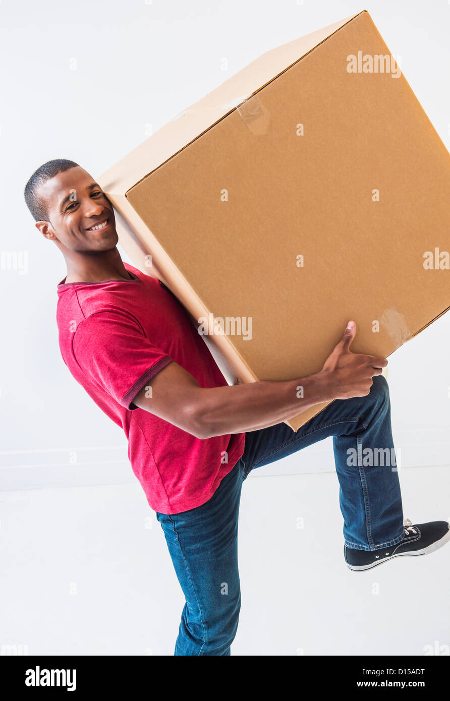Young man carrying large cardboard box hi-res stock photography and ...