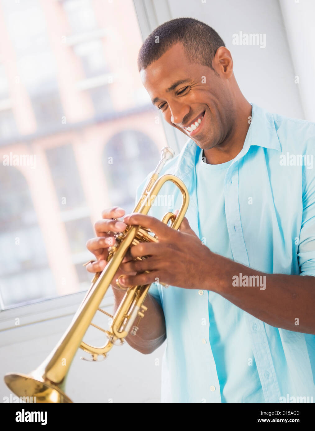 Young man playing trombone Stock Photo - Alamy