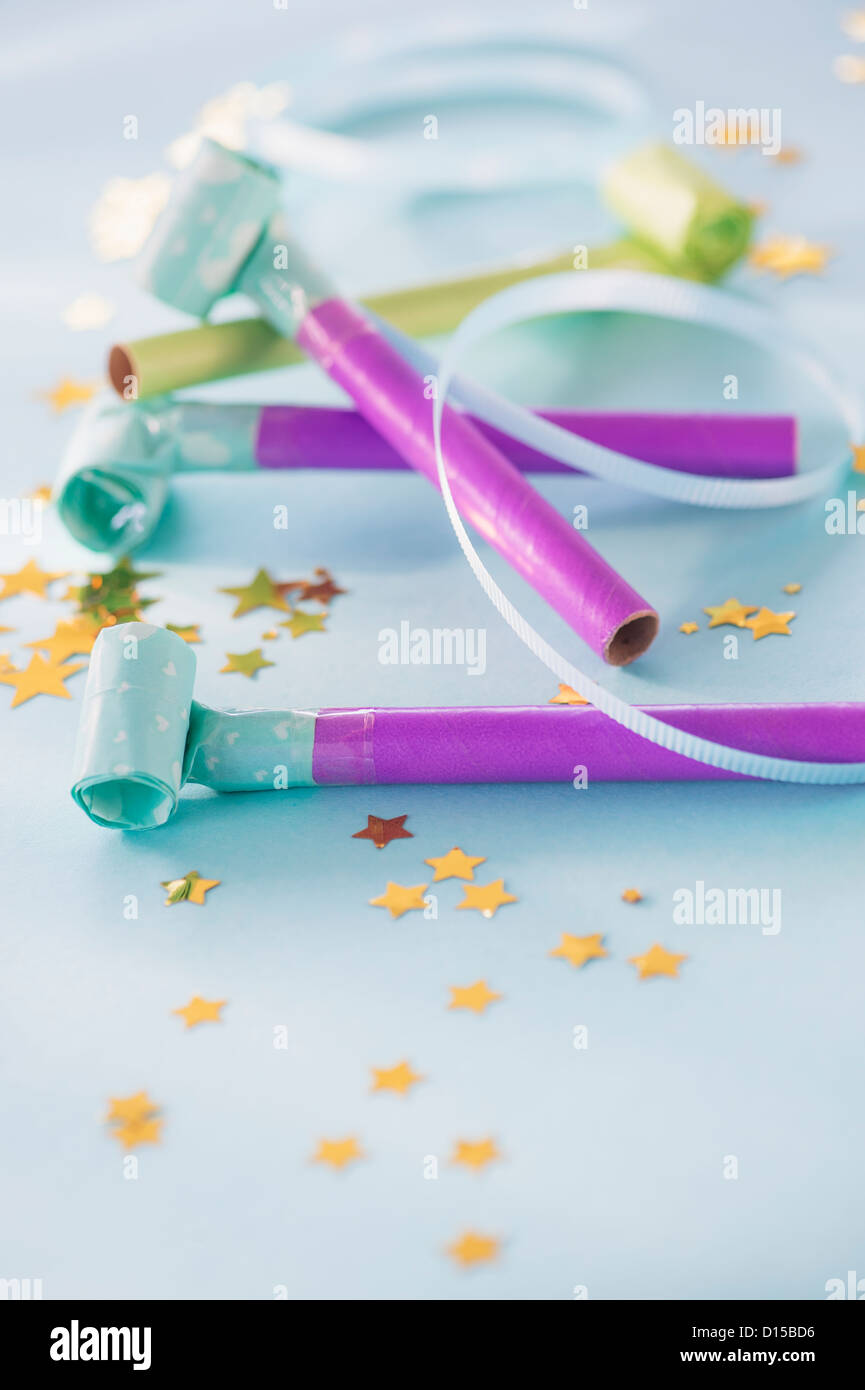 Studio shot of party blowers and confetti Stock Photo - Alamy