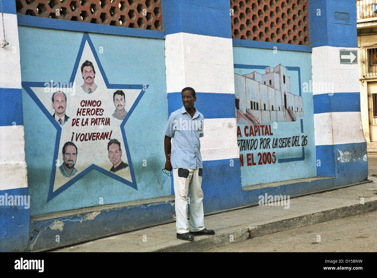 Havana, Cuba, man stands in front of a wall with a picture of the 5 ...