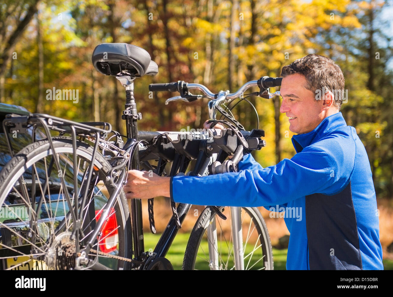 USA, New Jersey, Mendham, Man putting bicycle onto bike rack Stock ...
