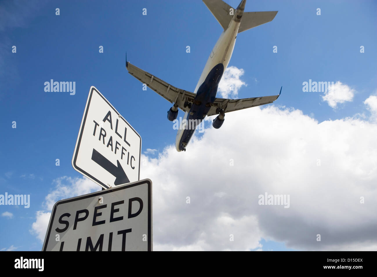 USA, New York State, New York City, Airplane flying above road signs ...