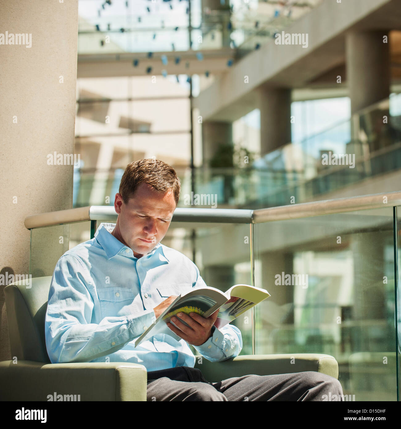 USA, Utah, Salt Lake City, Portrait of man reading in armchair Stock ...