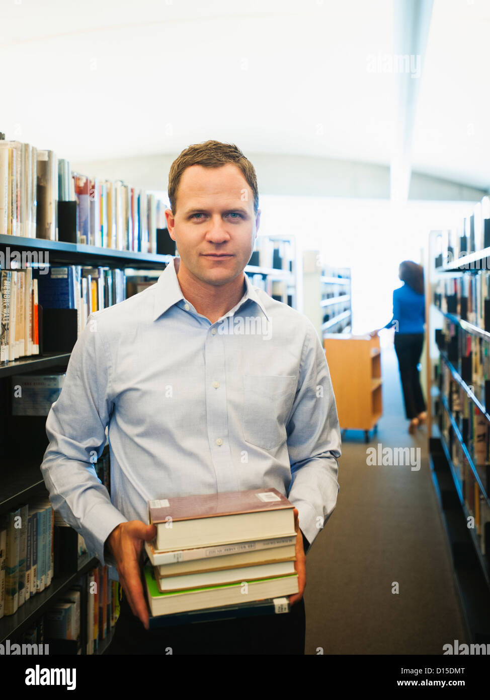 USA, Utah, Salt Lake City, Man holding books in library Stock Photo - Alamy