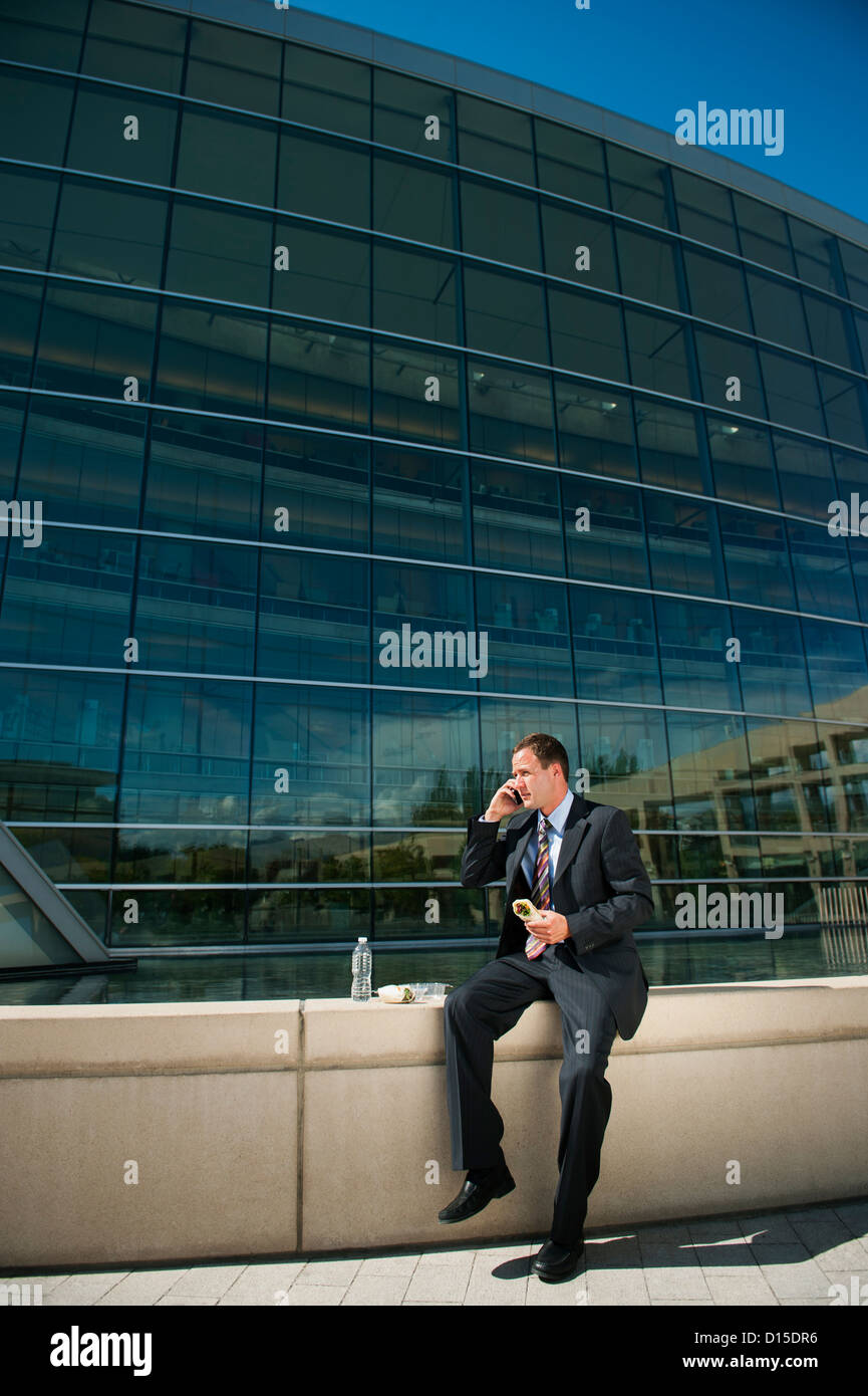 USA, Utah, Salt Lake City, Young man taking lunch brake on ledge Stock ...