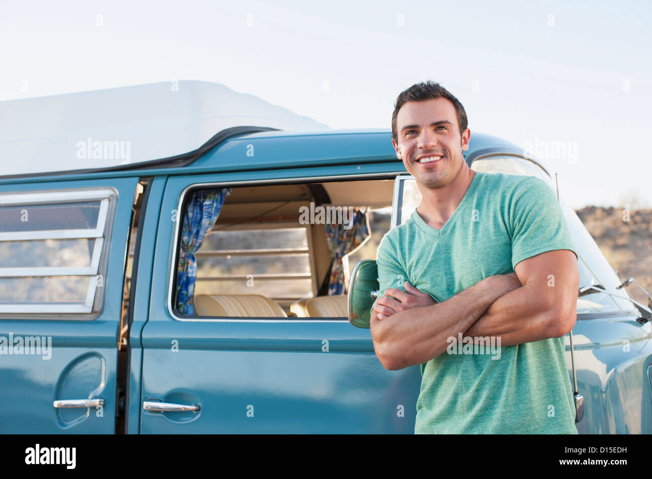 Man in front of his mini van during road trip Stock Photo - Alamy