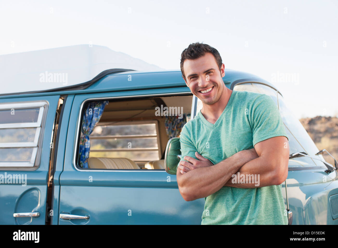 Man in front of his mini van during road trip Stock Photo - Alamy