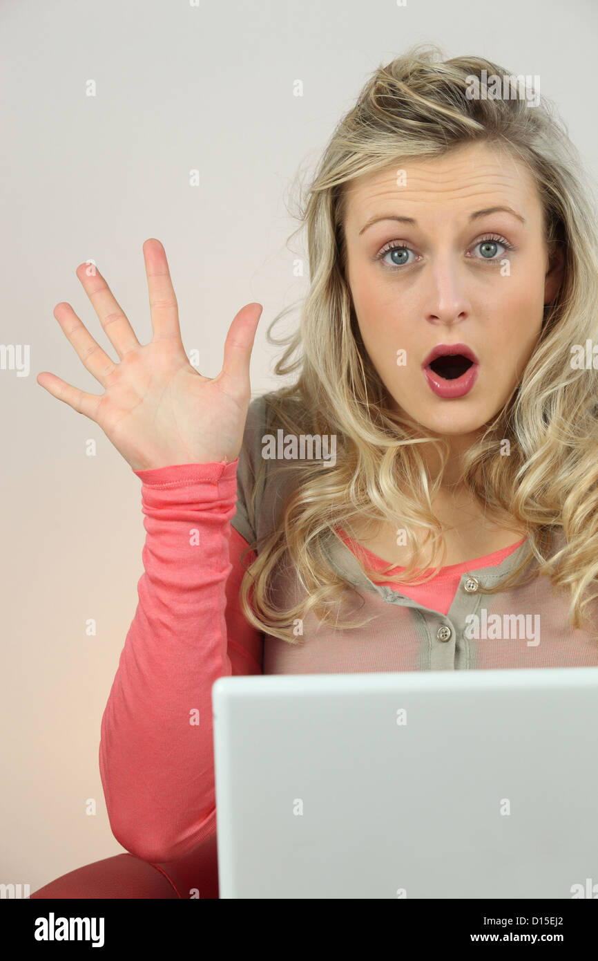 blonde woman surprised behind a computer Stock Photo - Alamy