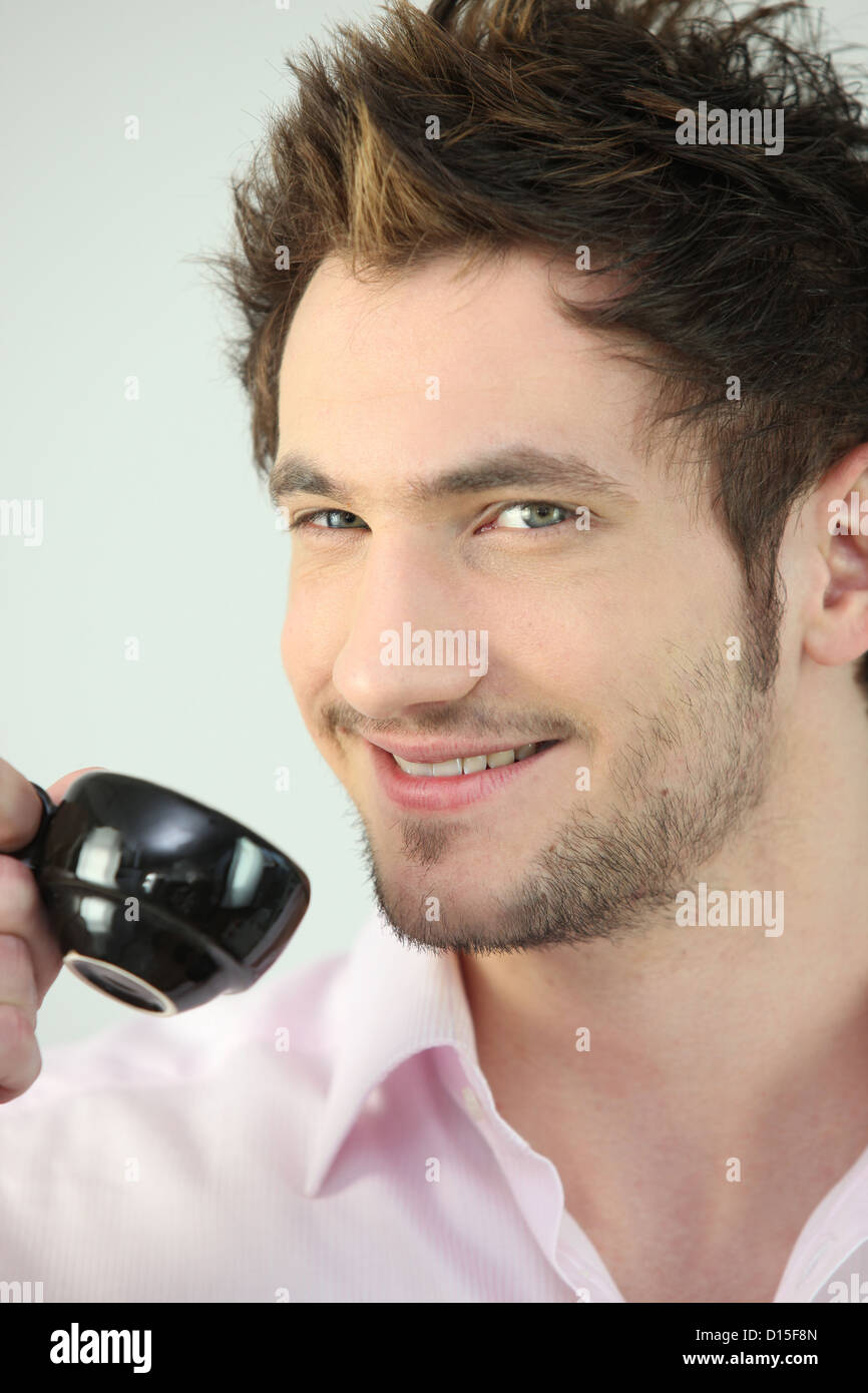 Smiling man drinking tea Stock Photo - Alamy