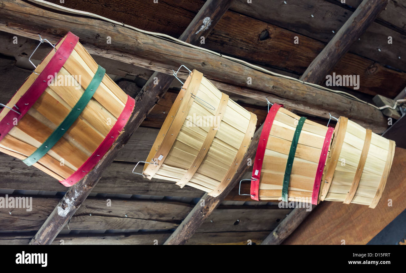 Woven wooden baskets hanging from wooden beam Stock Photo - Alamy