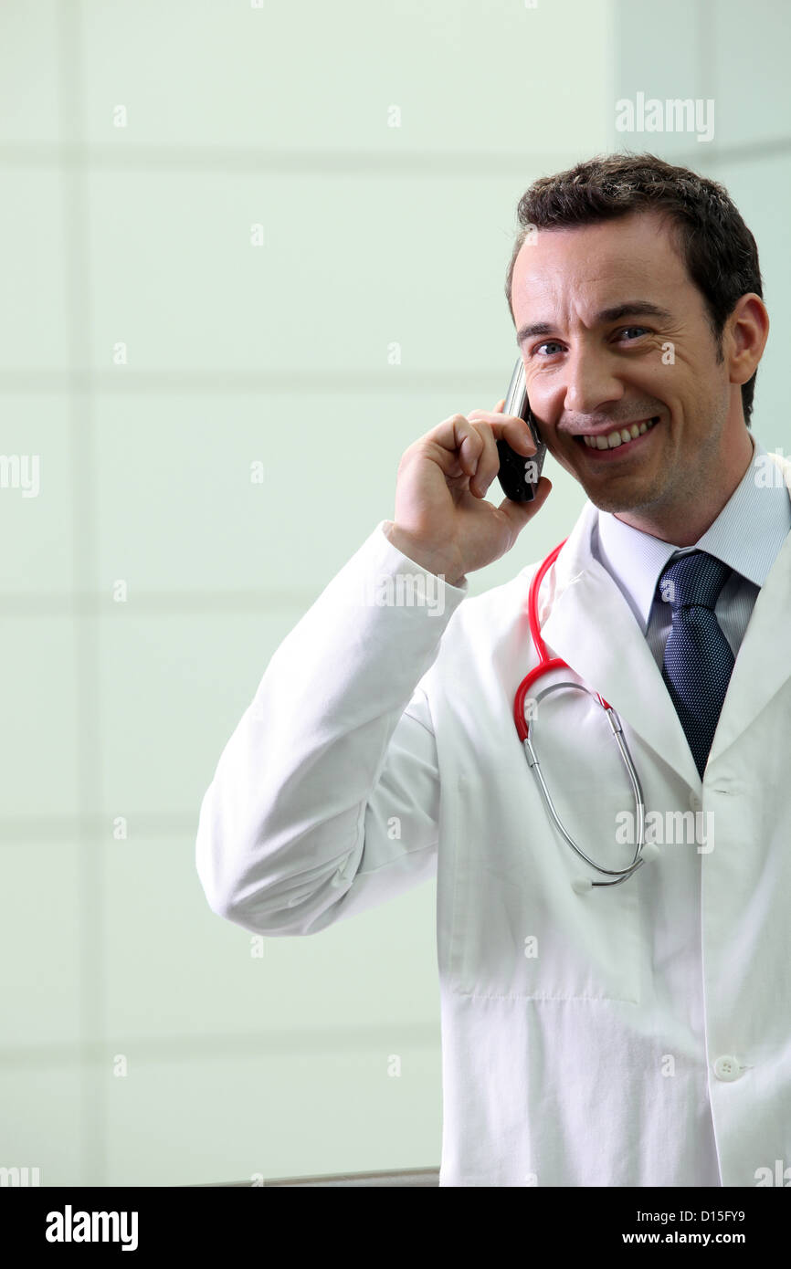 Hospital doctor using a telephone Stock Photo - Alamy