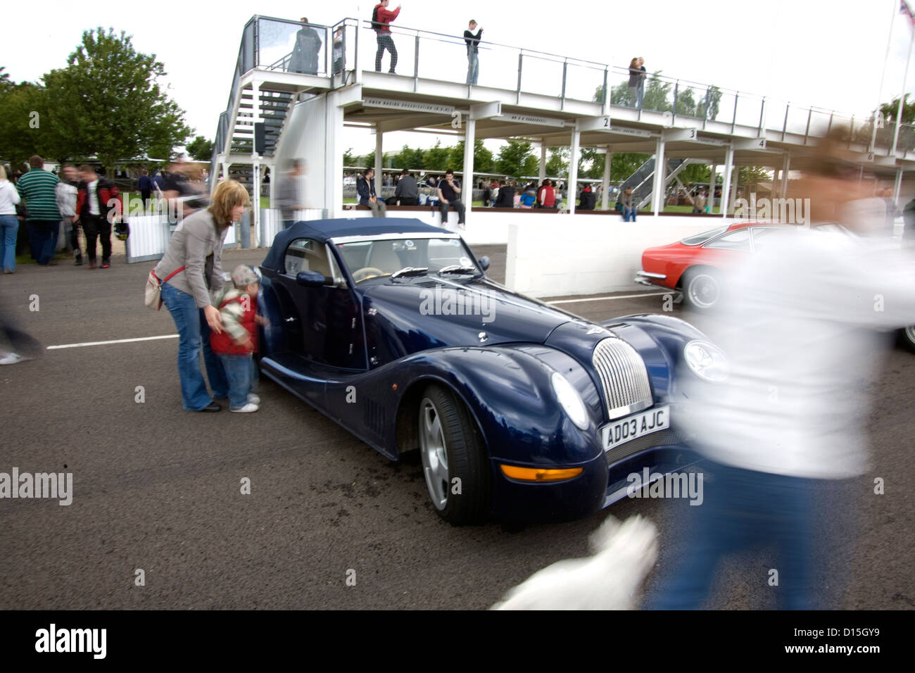 People moving around a blue Morgan car at a classic car show Stock ...