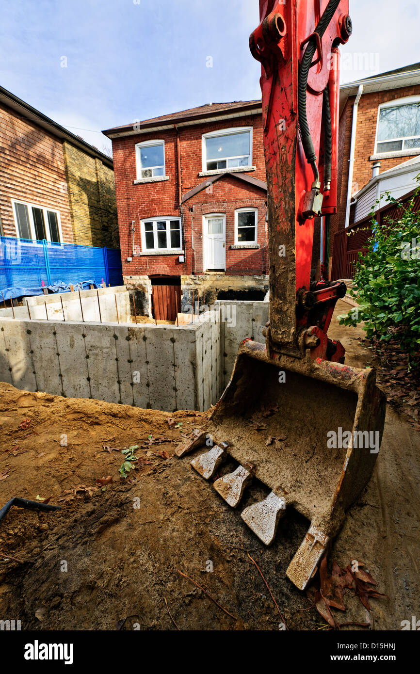 Backhoe scoop at residential home renovation construction site Stock ...