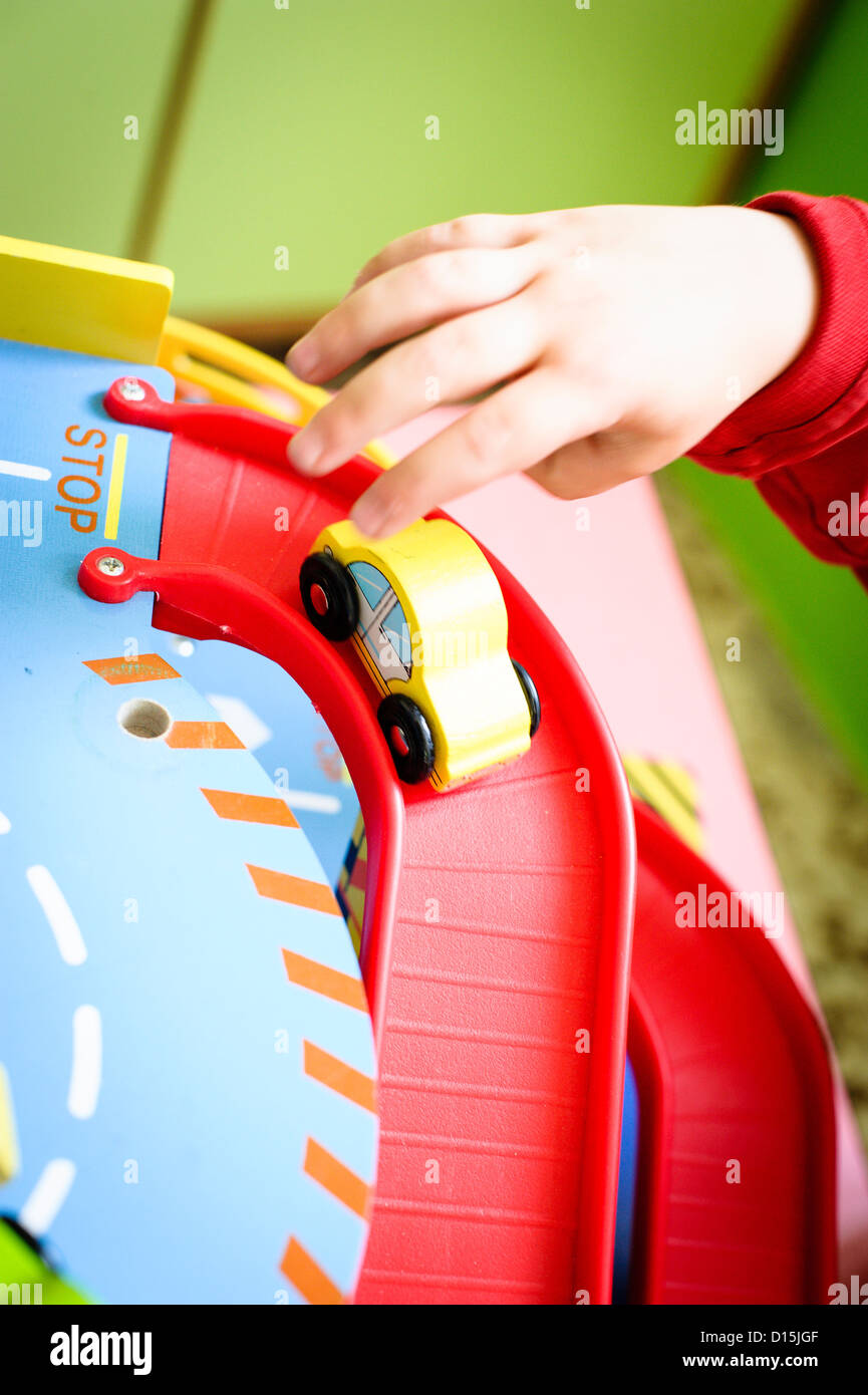hands of a child playing with toy car Stock Photo - Alamy