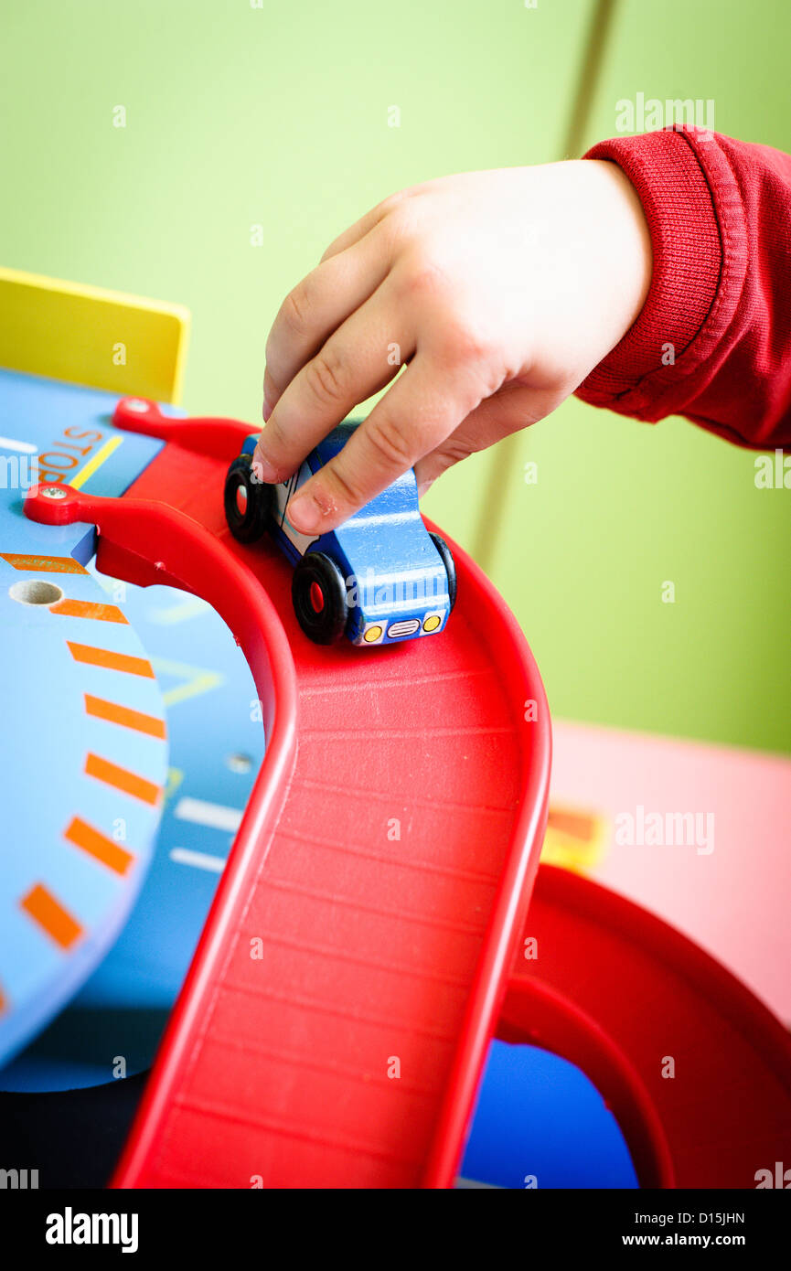 hands of a child playing with toy car Stock Photo - Alamy