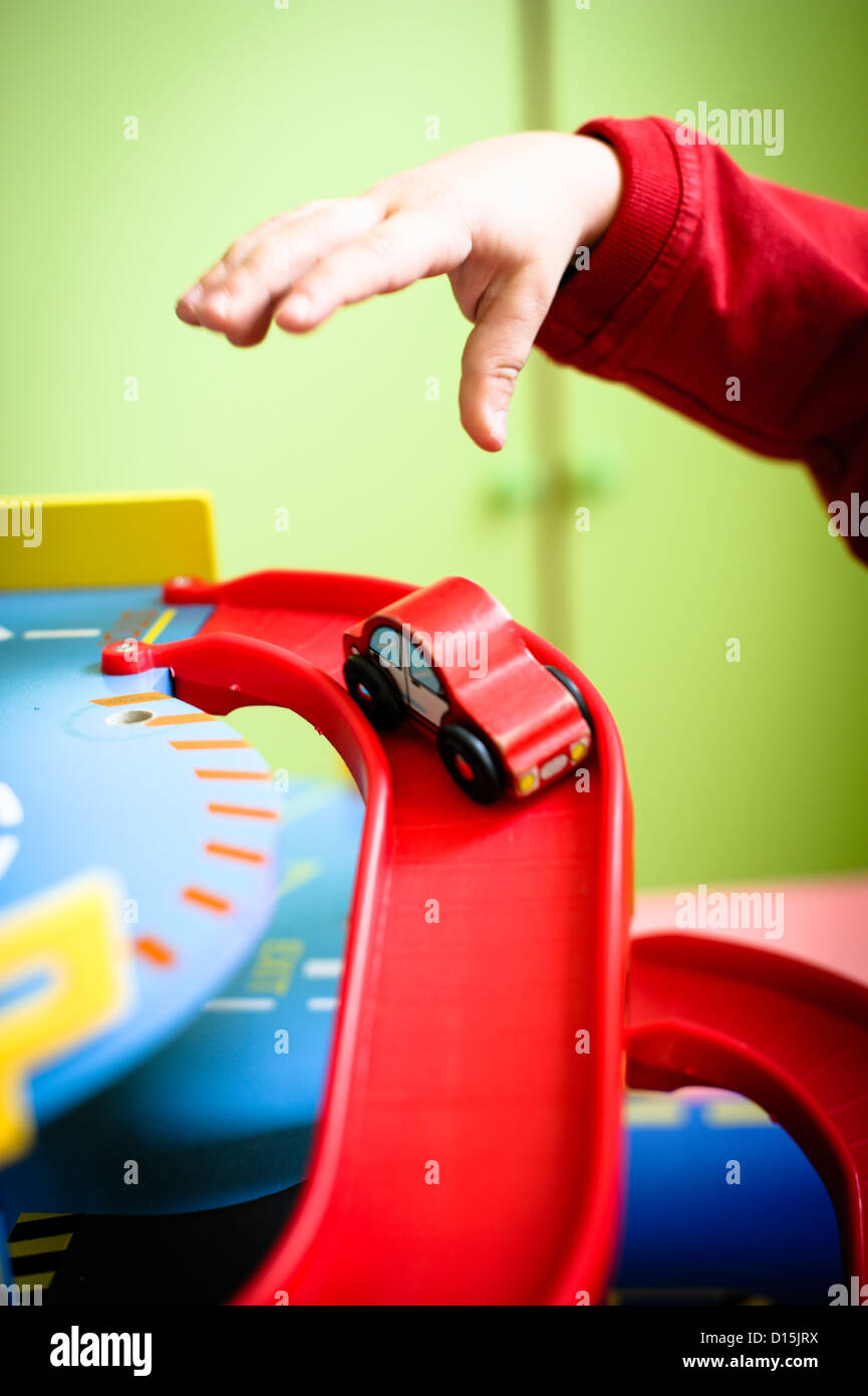 hands of a child playing with toy car Stock Photo - Alamy