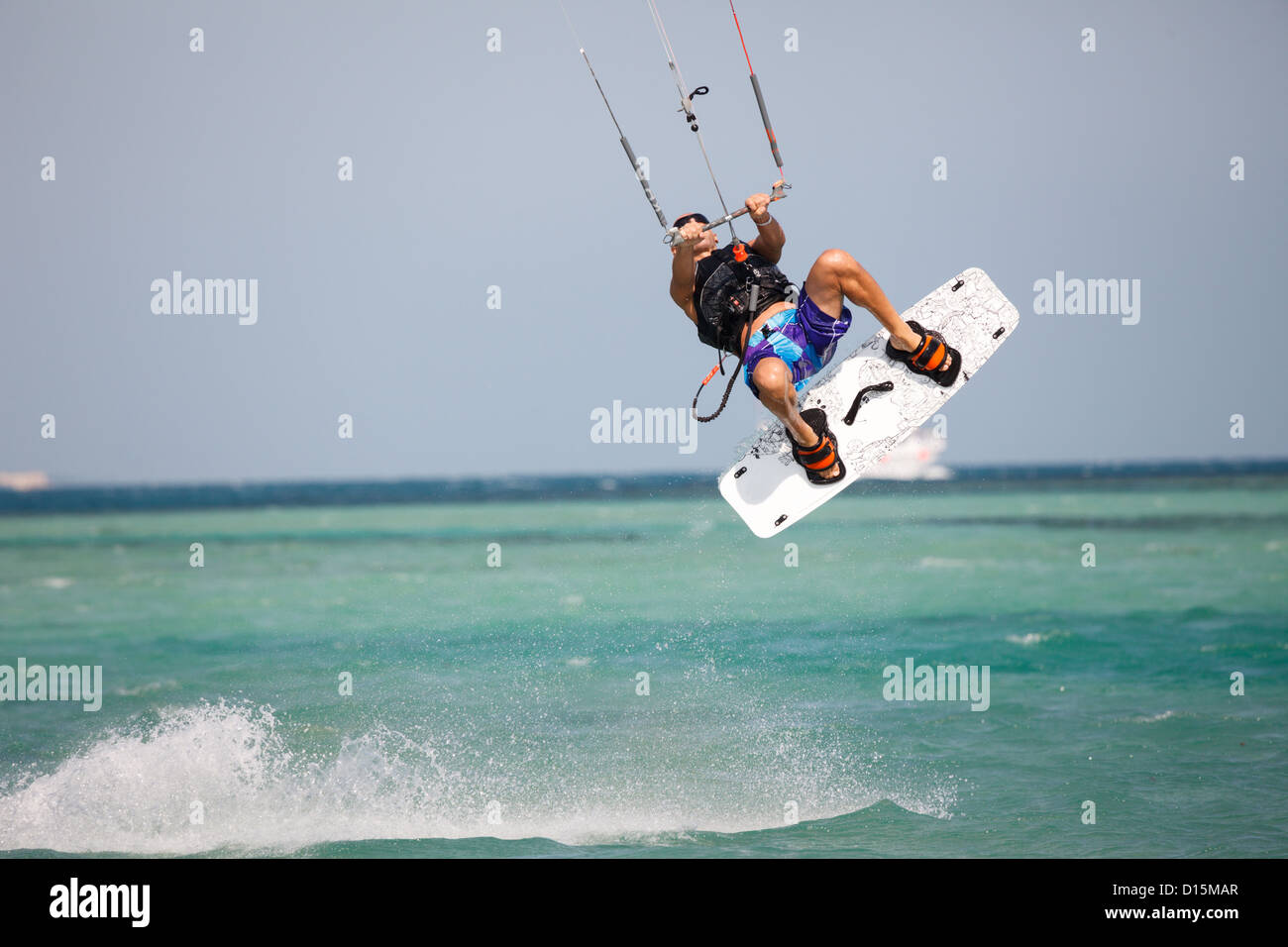 Kiteboarder enjoy surfing in blue water and jumps high in the air Stock ...