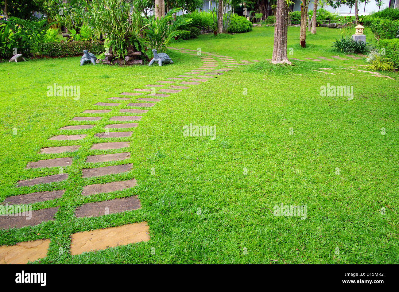 Garden stone path with grass Stock Photo - Alamy